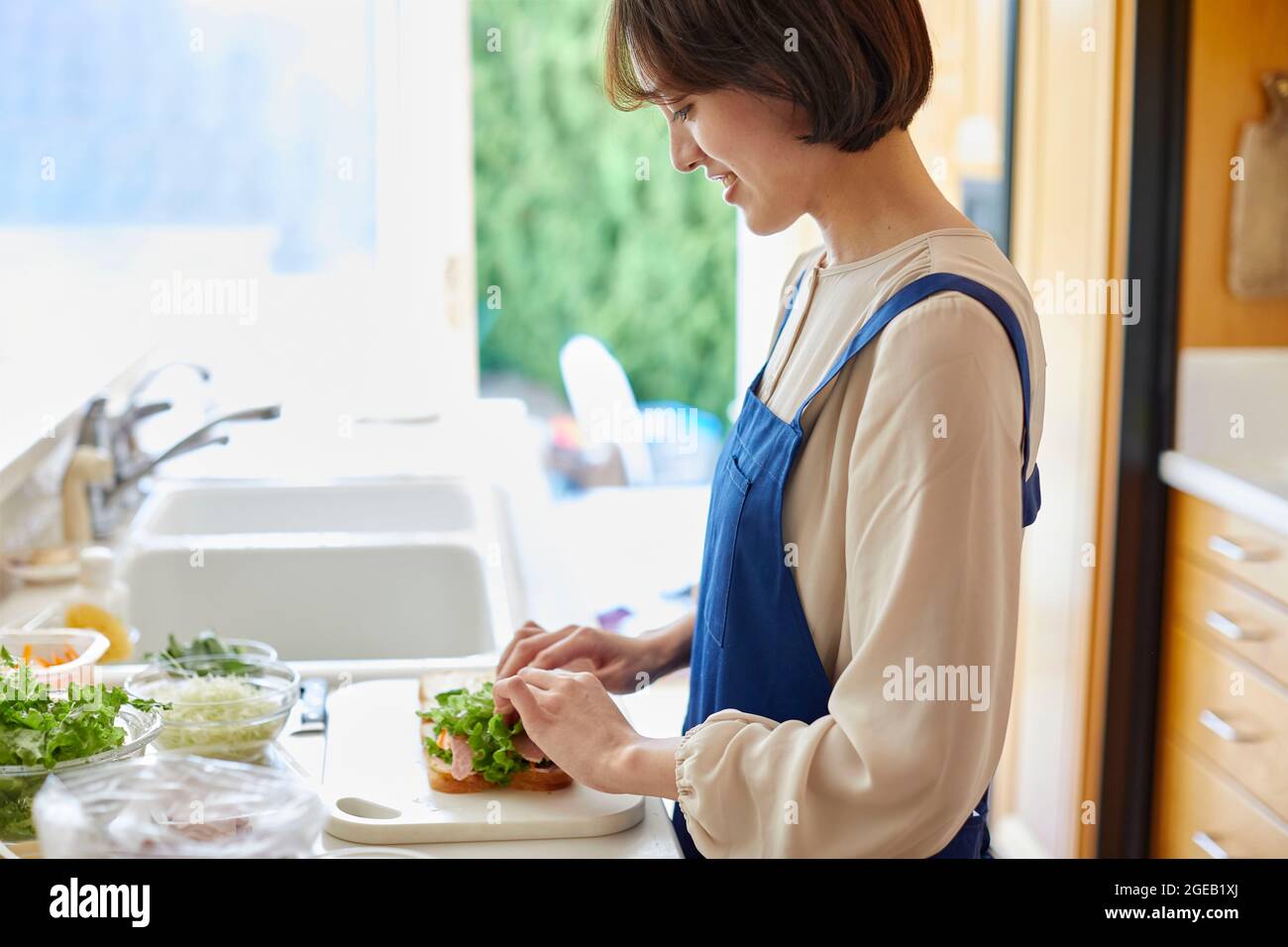 Japanese woman cooking at home Stock Photo - Alamy