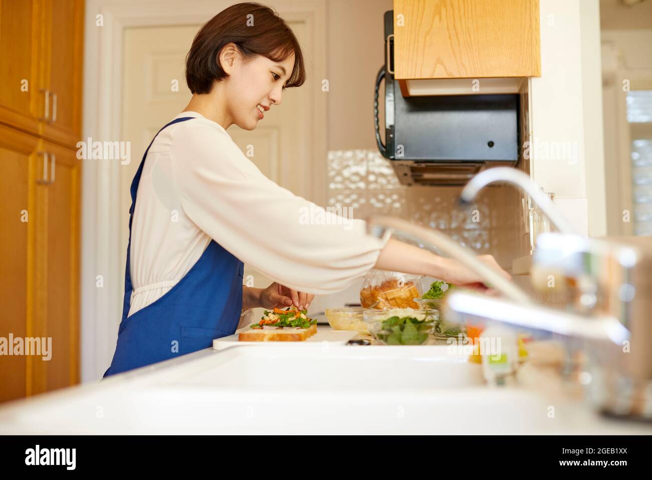 Japanese woman cooking at home Stock Photo - Alamy