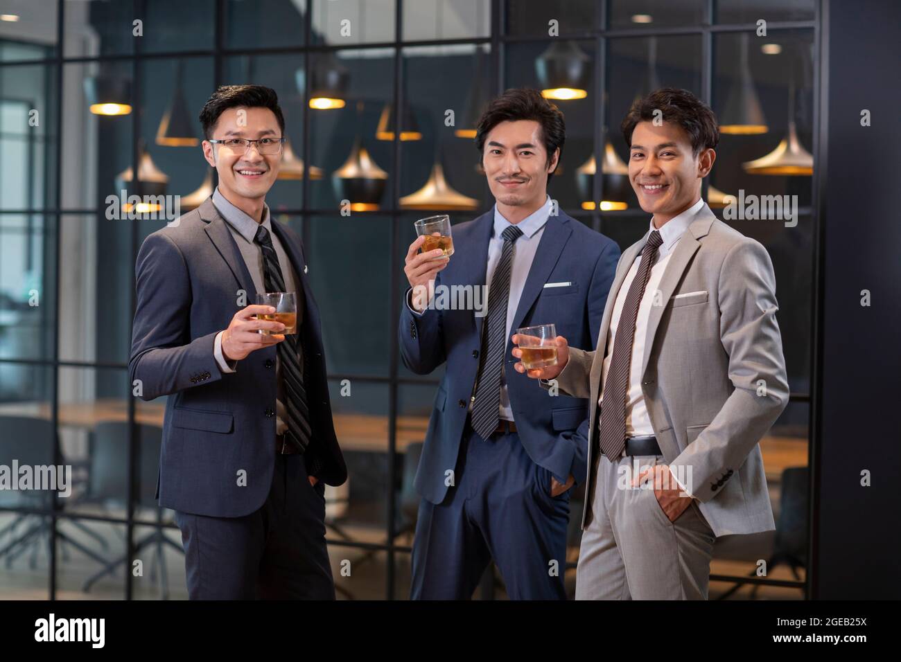 Successful Chinese businessmen drinking alcohol in office Stock Photo ...