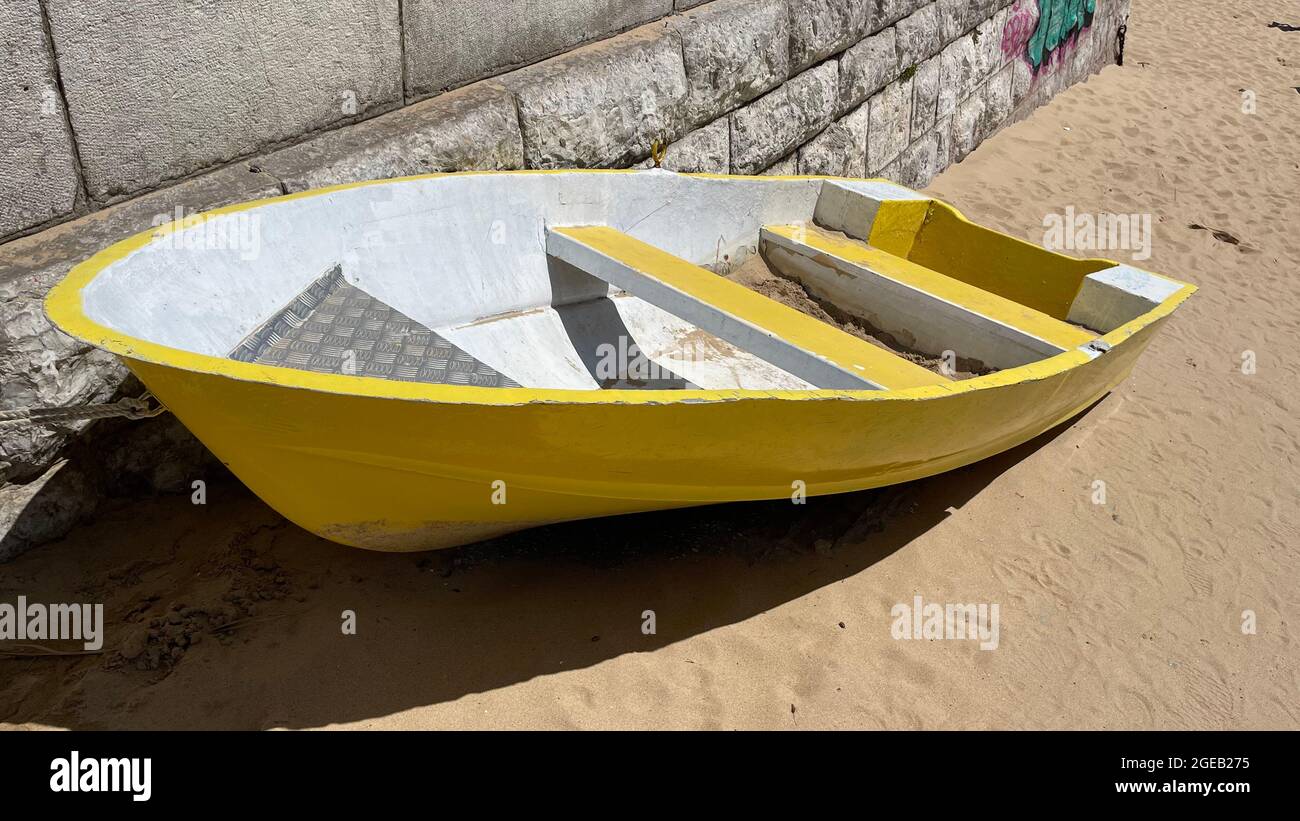 Small yellow boat on the beach Stock Photo - Alamy
