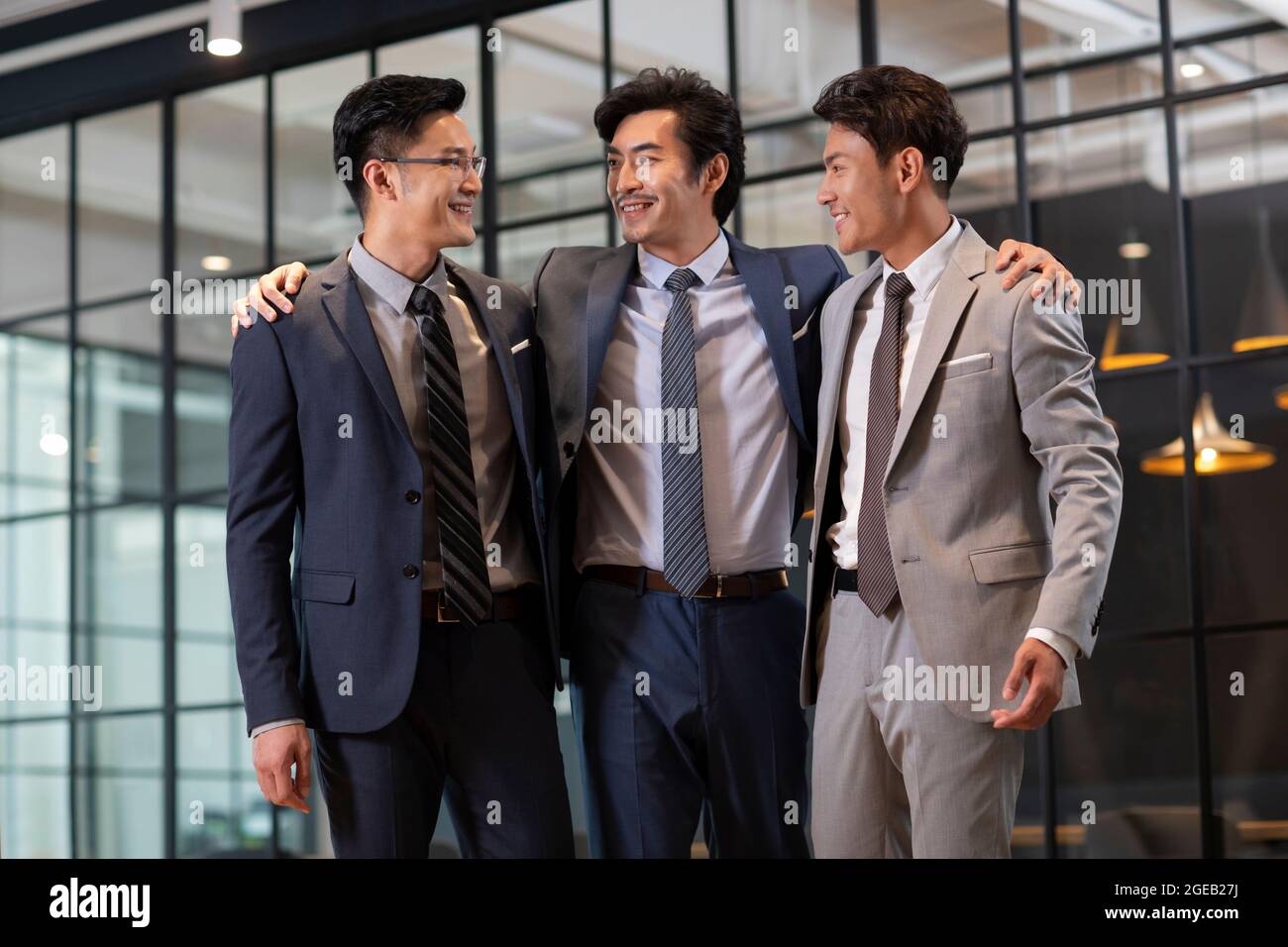 Successful Chinese businessmen talking in office Stock Photo - Alamy