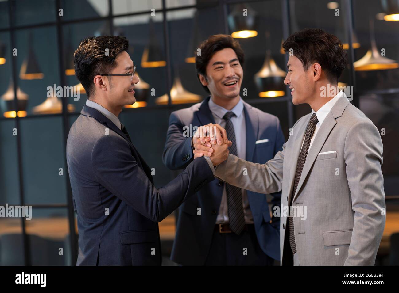 Successful Chinese businessmen celebrating in office Stock Photo - Alamy