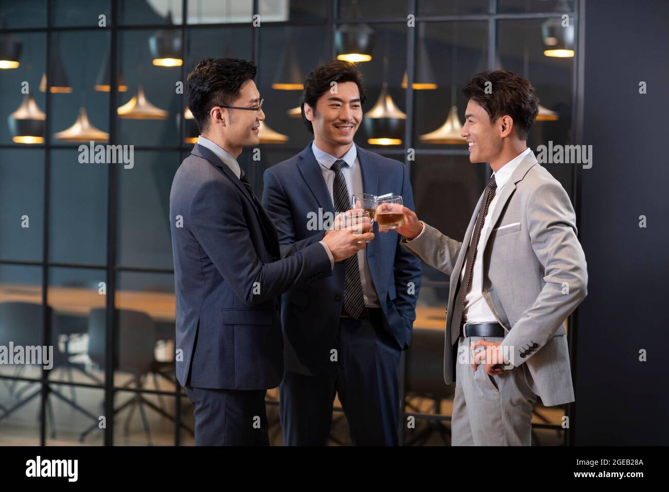 Successful Chinese businessmen drinking a toast in office Stock Photo ...