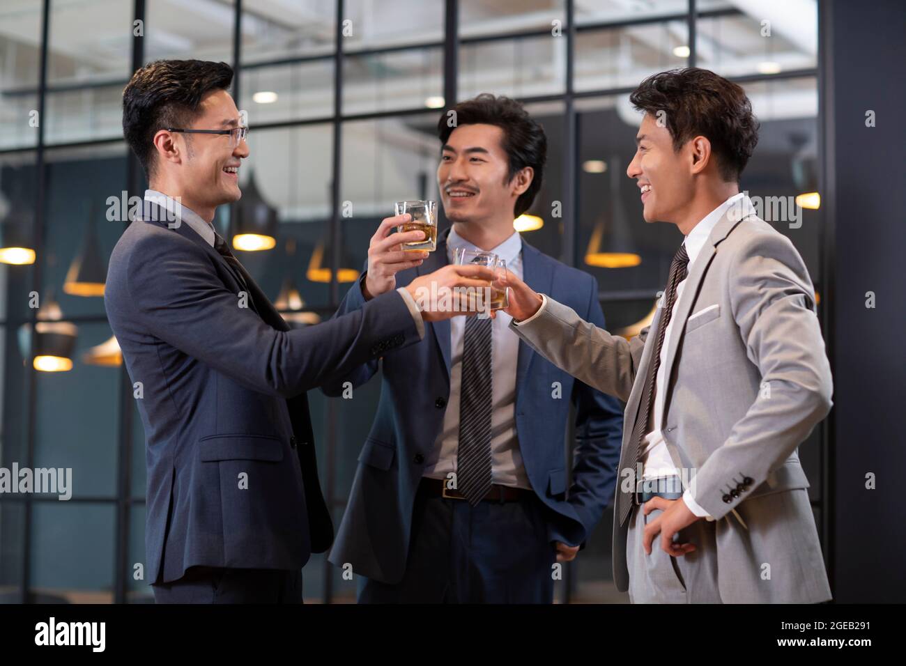 Successful Chinese businessmen drinking a toast in office Stock Photo ...