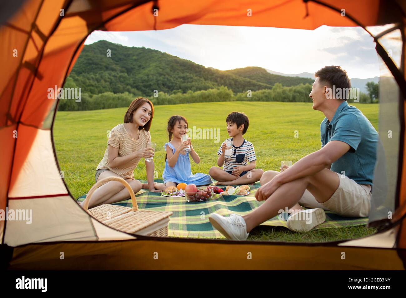 Happy young Chinese family having a picnic outdoors Stock Photo - Alamy
