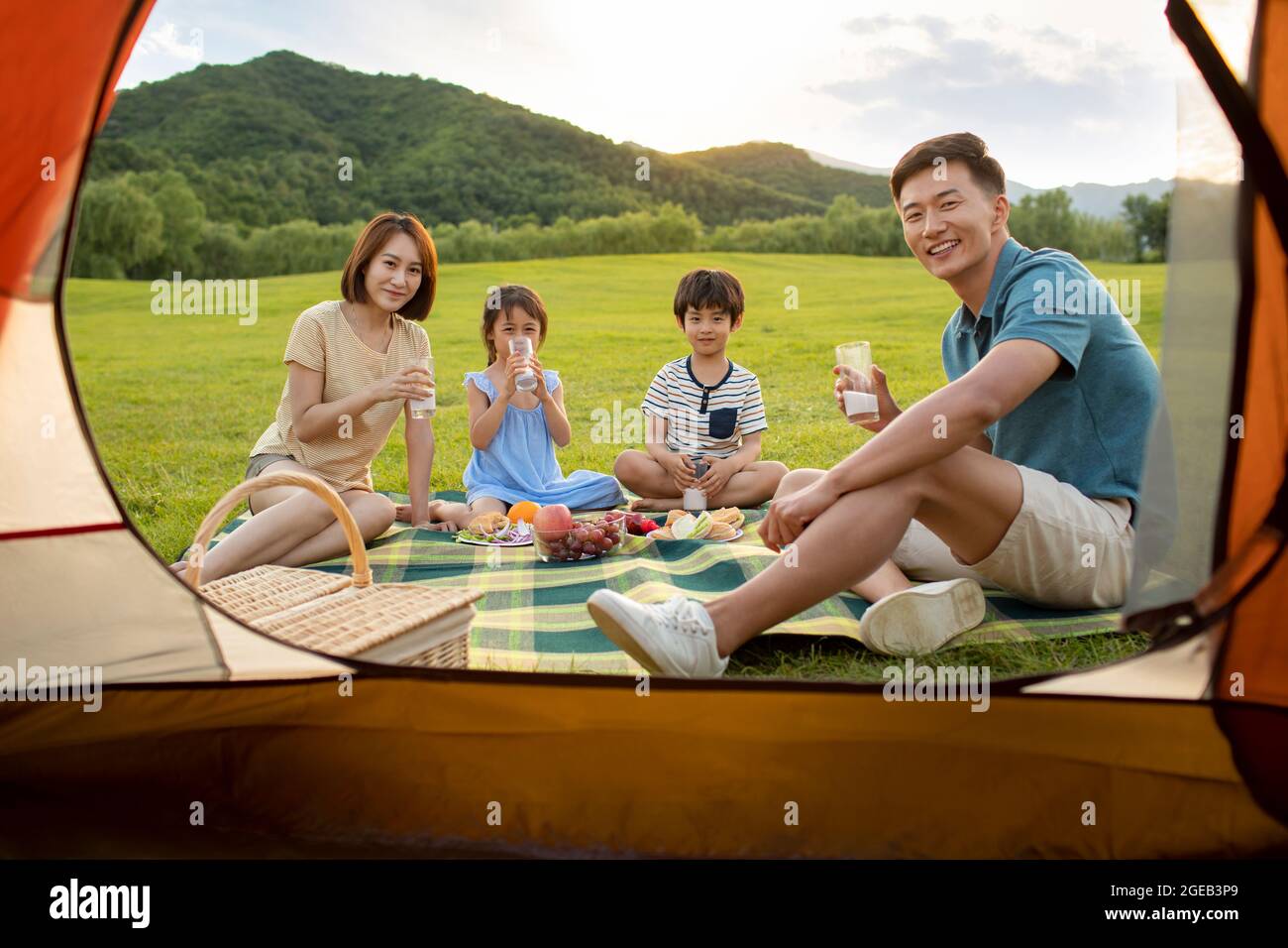Happy young Chinese family having a picnic outdoors Stock Photo - Alamy