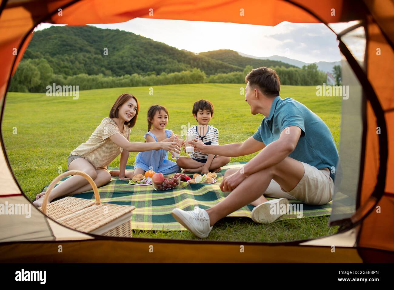 Happy young Chinese family having a picnic outdoors Stock Photo - Alamy