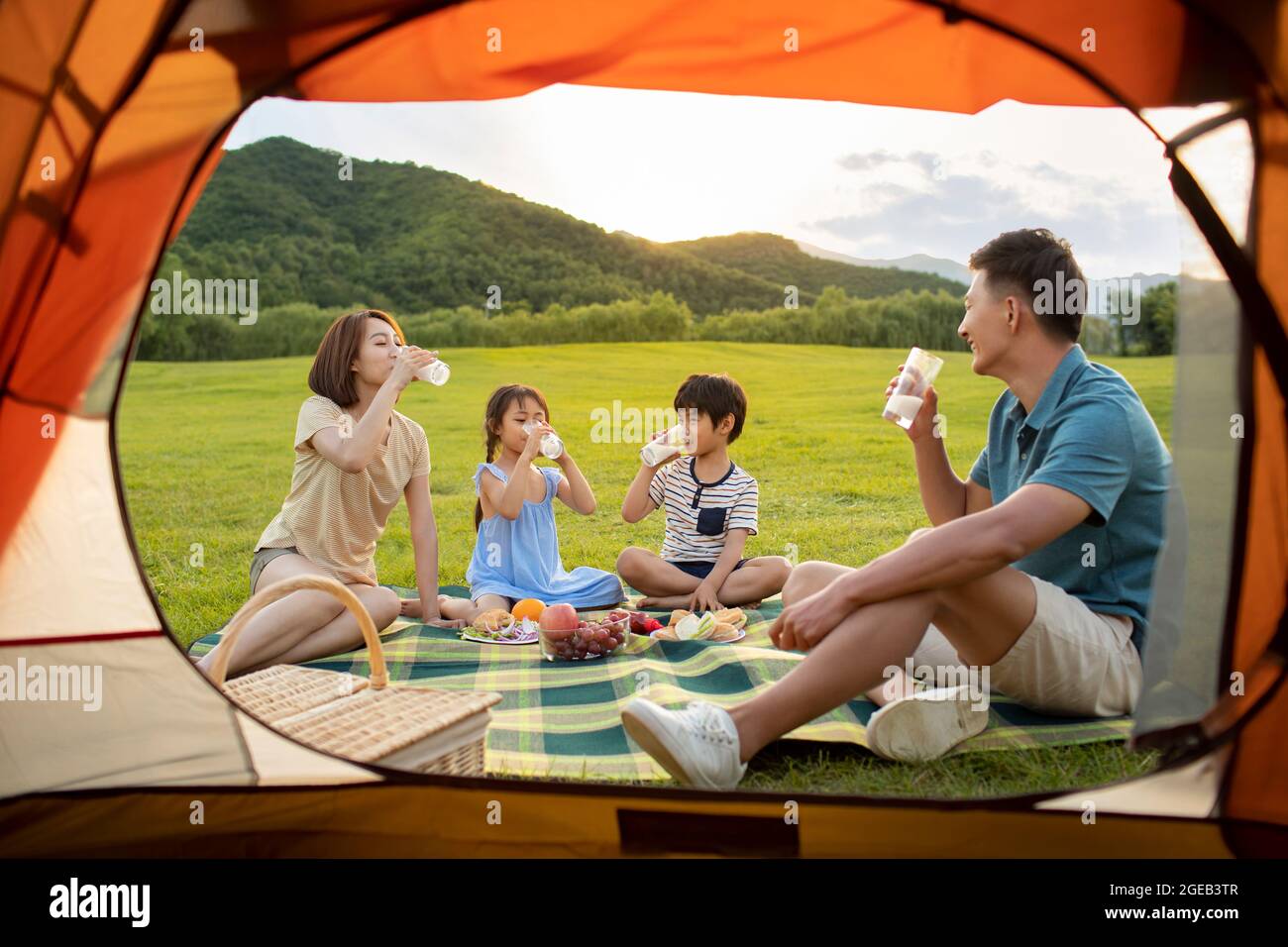Happy young Chinese family having a picnic outdoors Stock Photo - Alamy