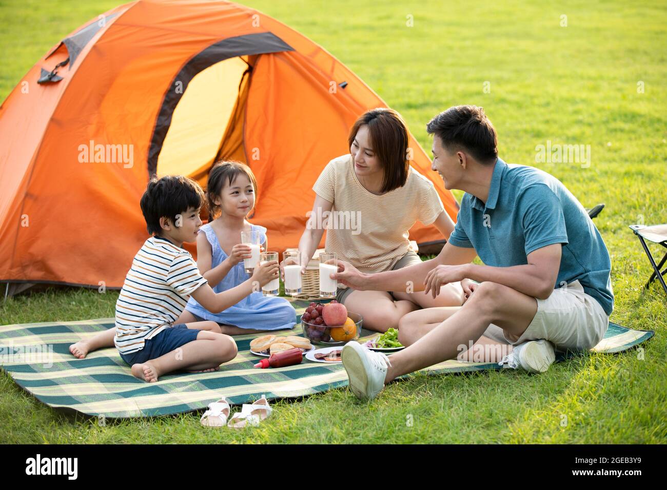 Happy young Chinese family having a picnic outdoors Stock Photo - Alamy