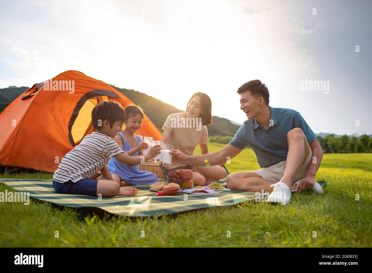 Happy young Chinese family having a picnic outdoors Stock Photo - Alamy