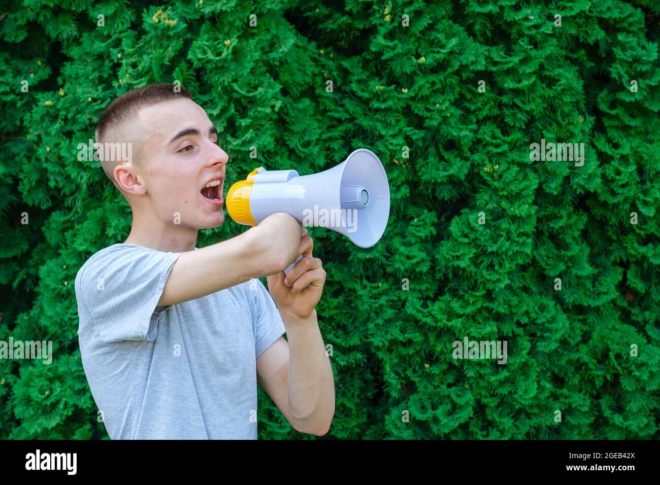 Young man with disability shouting into a megaphone Stock Photo - Alamy
