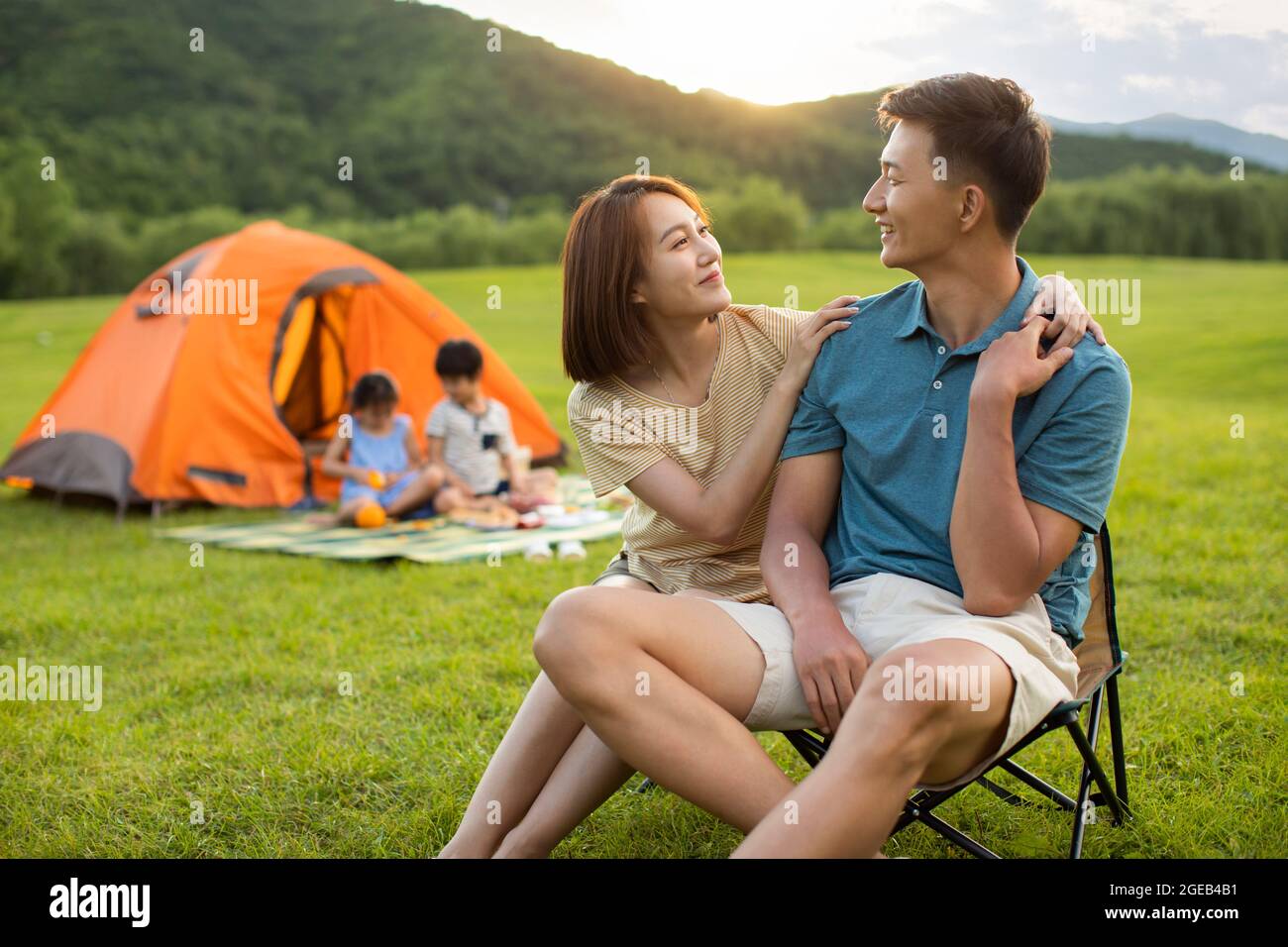 Happy young Chinese family having a picnic outdoors Stock Photo - Alamy