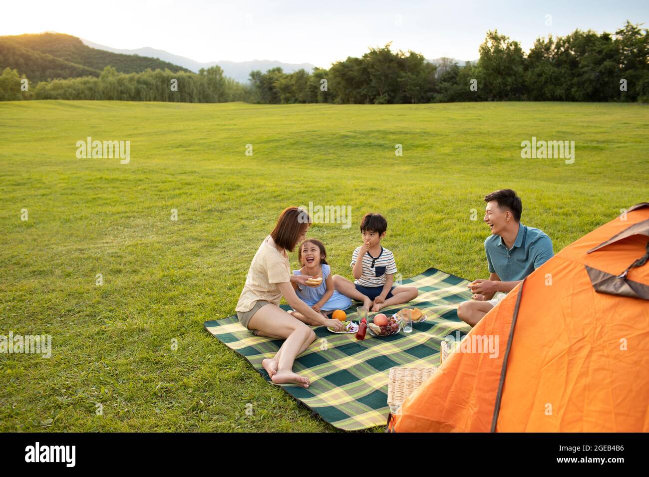 Happy young Chinese family having a picnic outdoors Stock Photo - Alamy