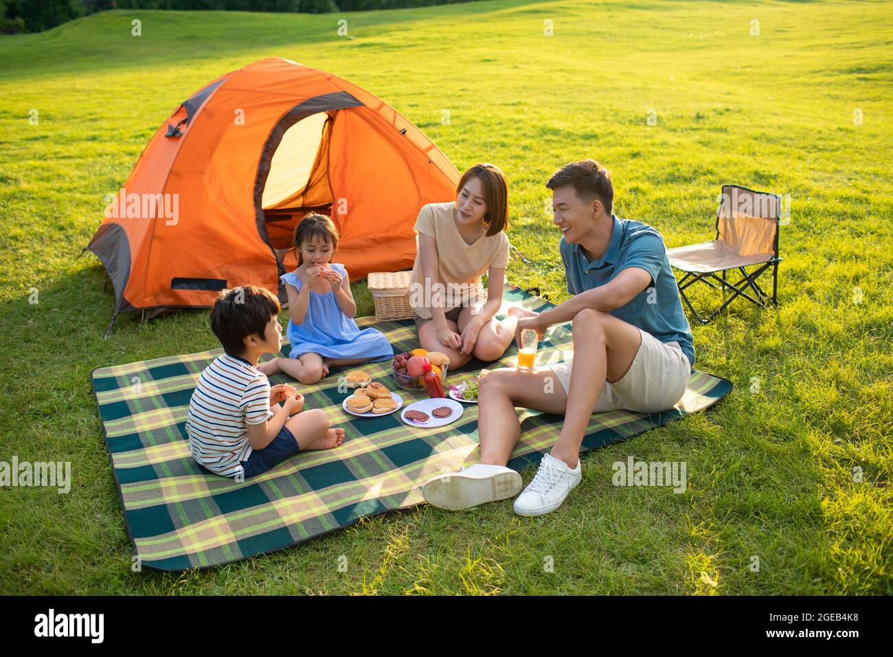 Happy young Chinese family having a picnic outdoors Stock Photo - Alamy