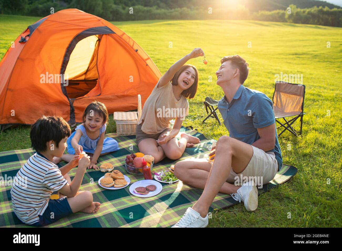 Happy young Chinese family having a picnic outdoors Stock Photo - Alamy