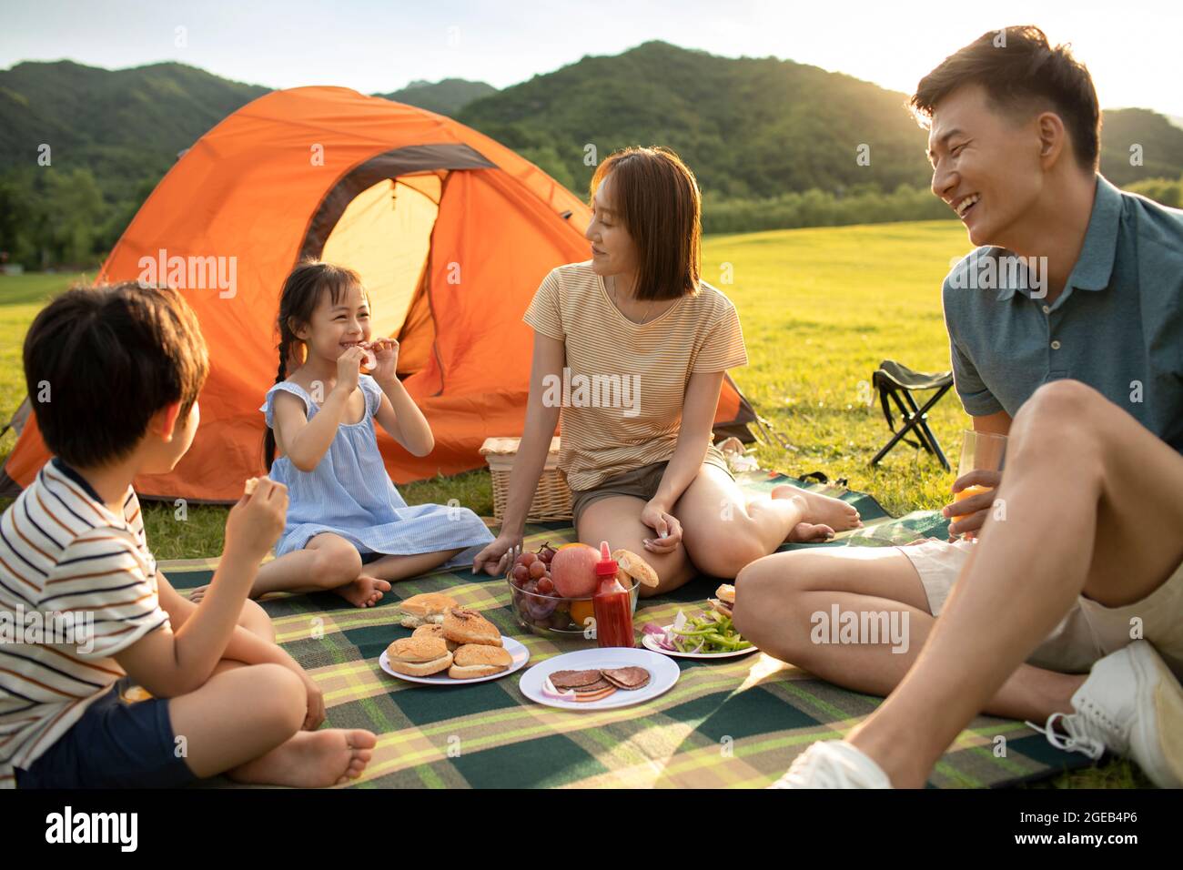 Happy young Chinese family having a picnic outdoors Stock Photo - Alamy