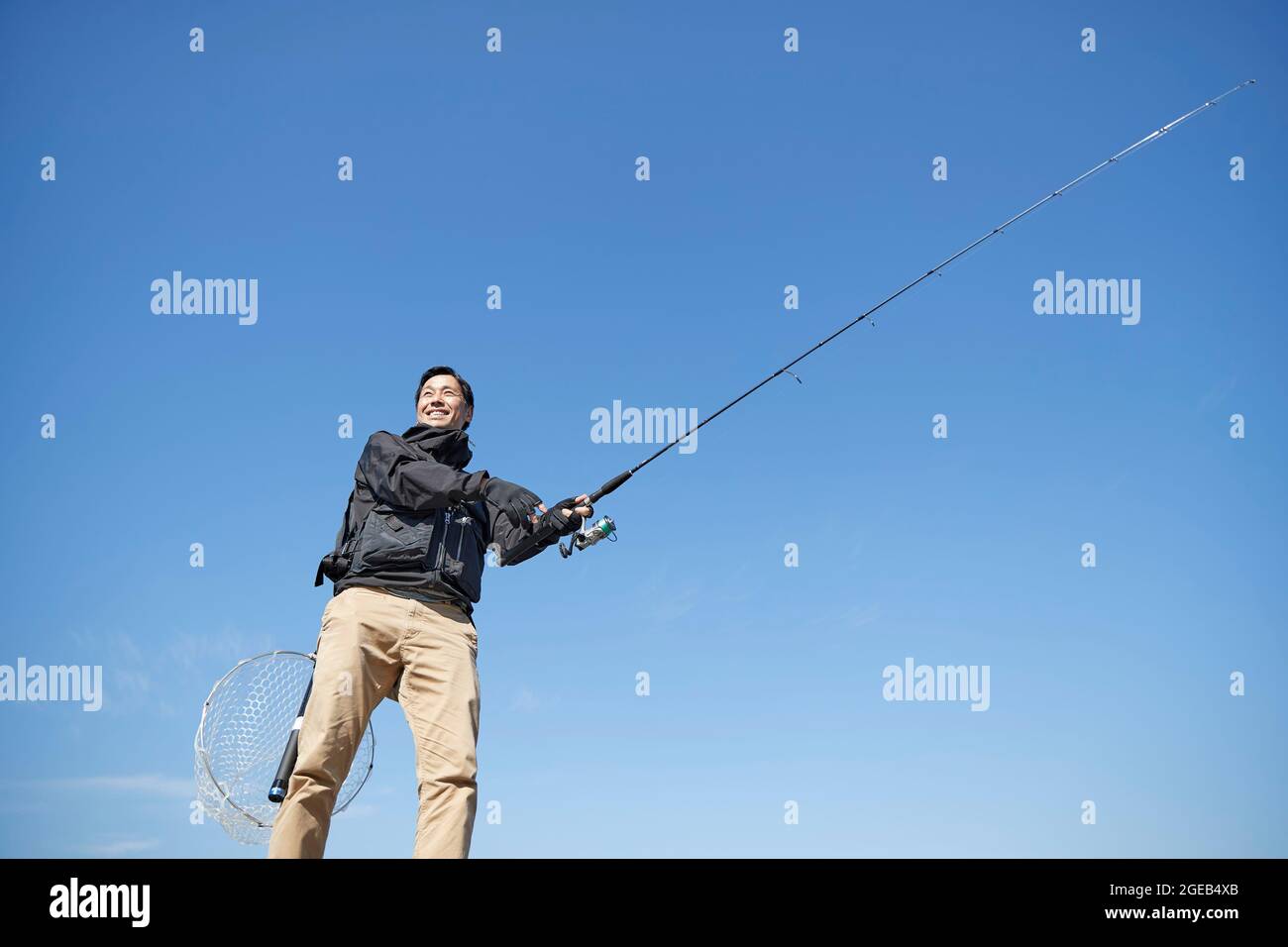 Japanese man fishing Stock Photo - Alamy
