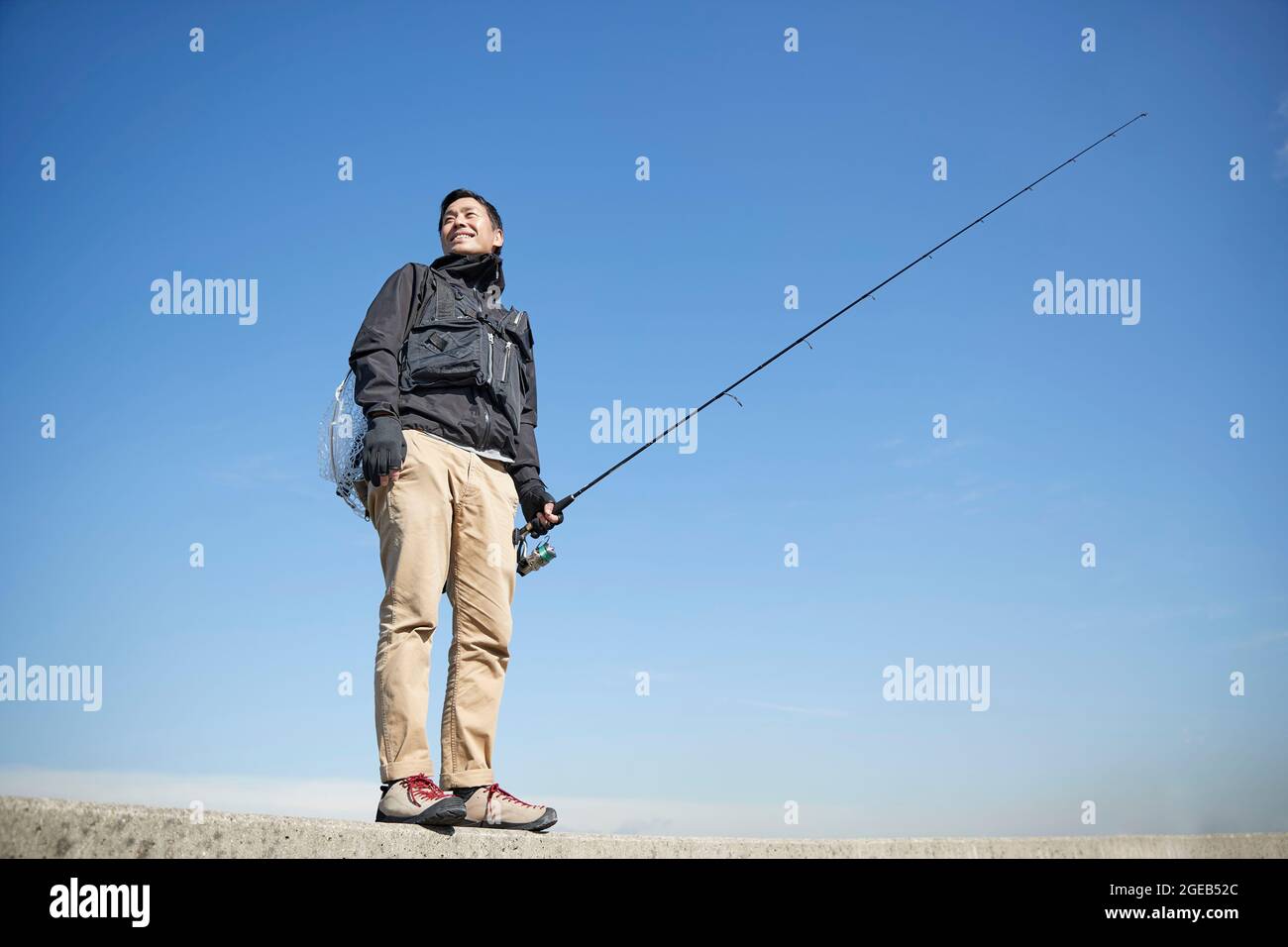 Japanese man fishing Stock Photo - Alamy