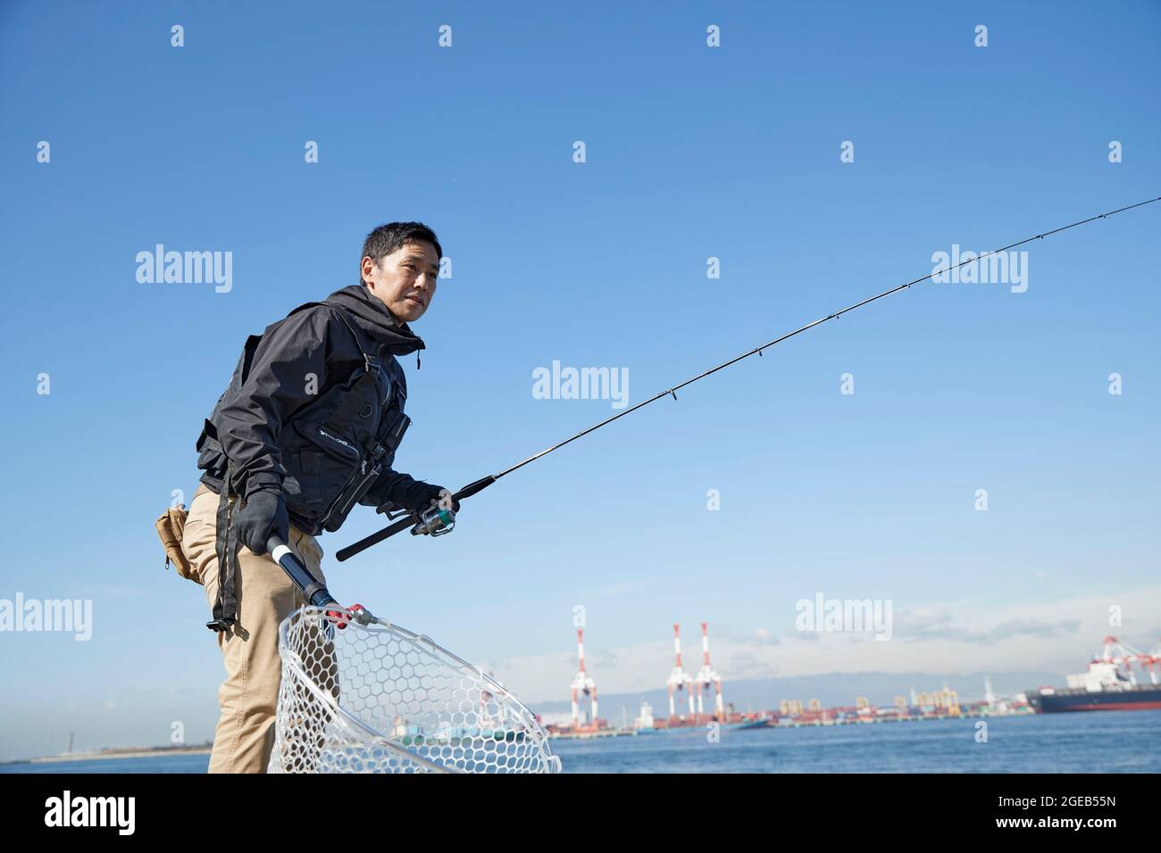 Japanese man fishing Stock Photo - Alamy