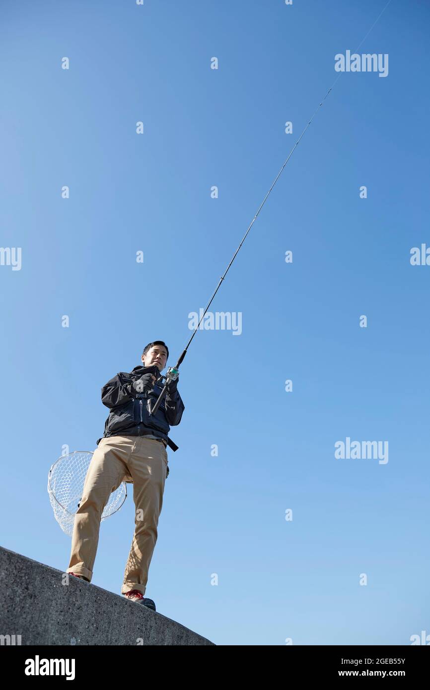 Japanese man fishing Stock Photo - Alamy