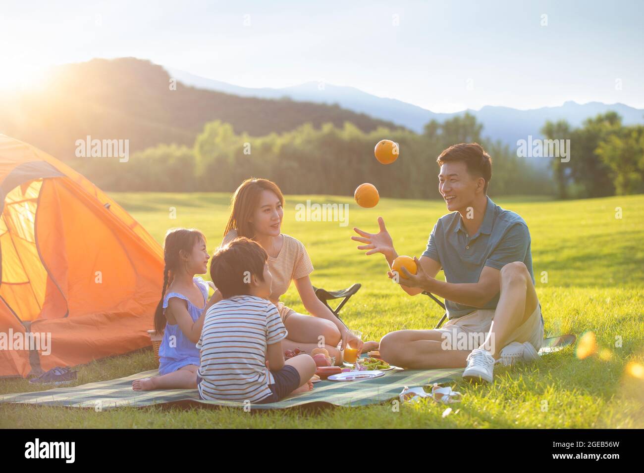 Happy young Chinese family having a picnic outdoors Stock Photo - Alamy
