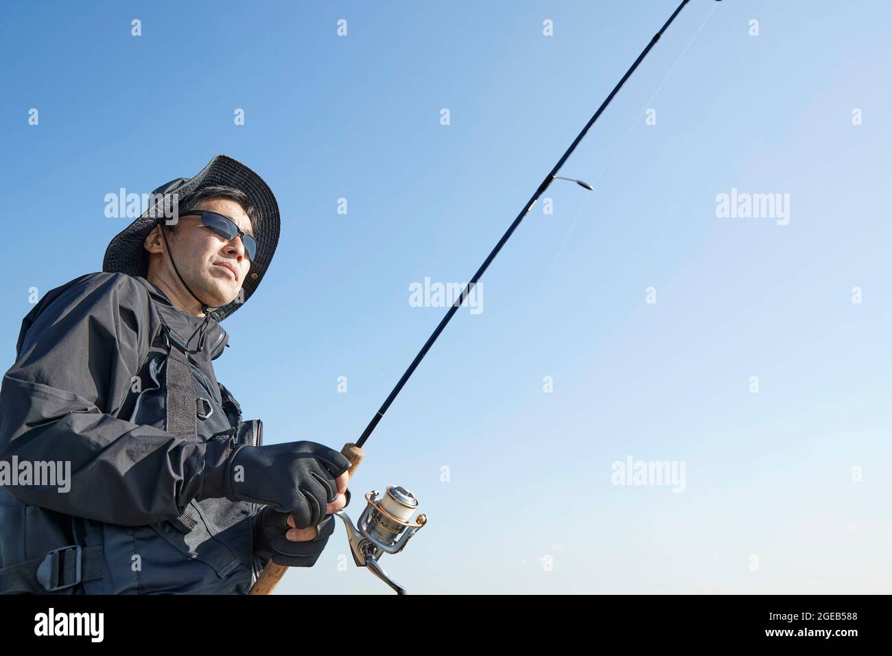 Japanese man fishing Stock Photo - Alamy