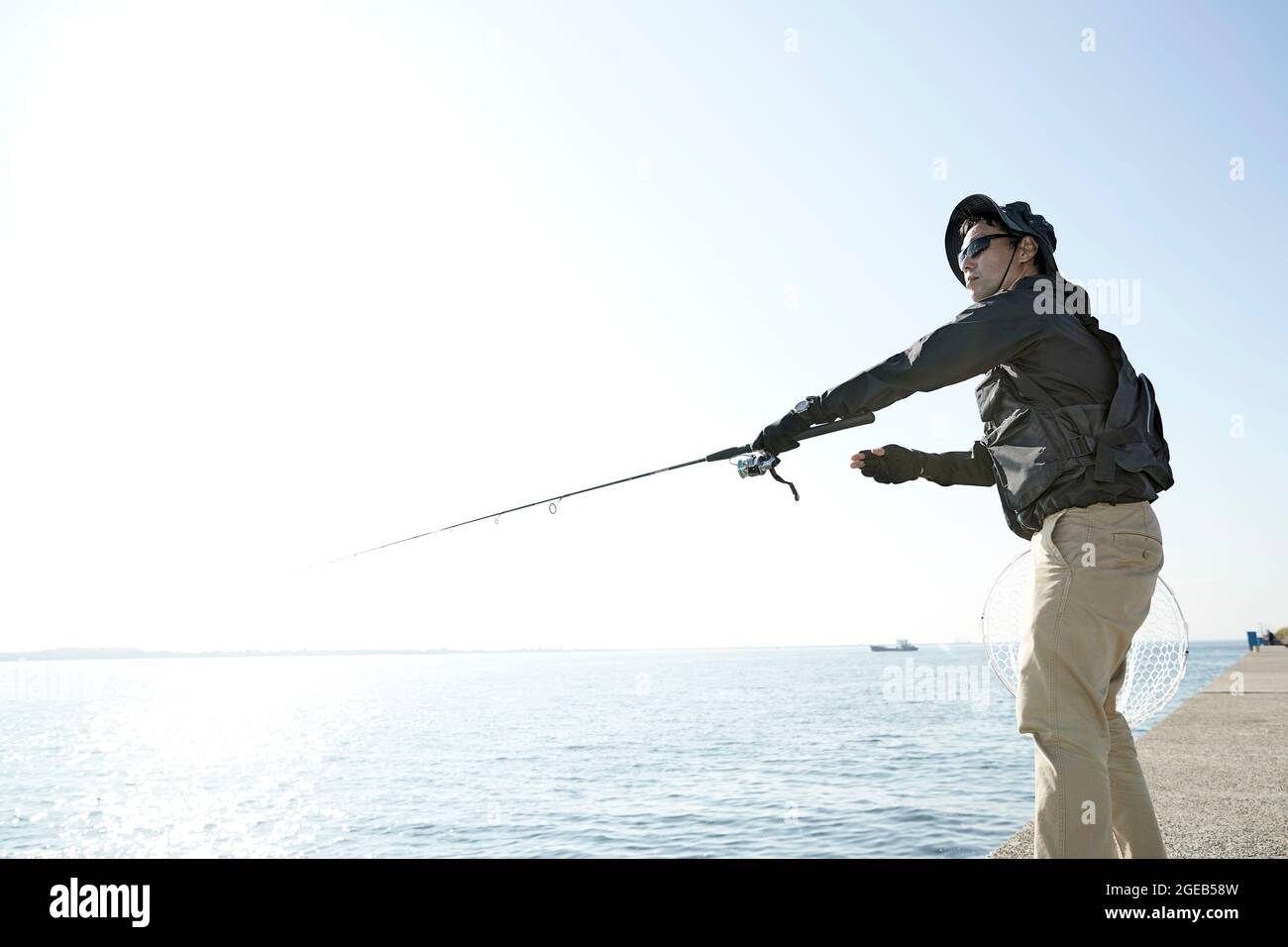 Japanese man fishing Stock Photo - Alamy