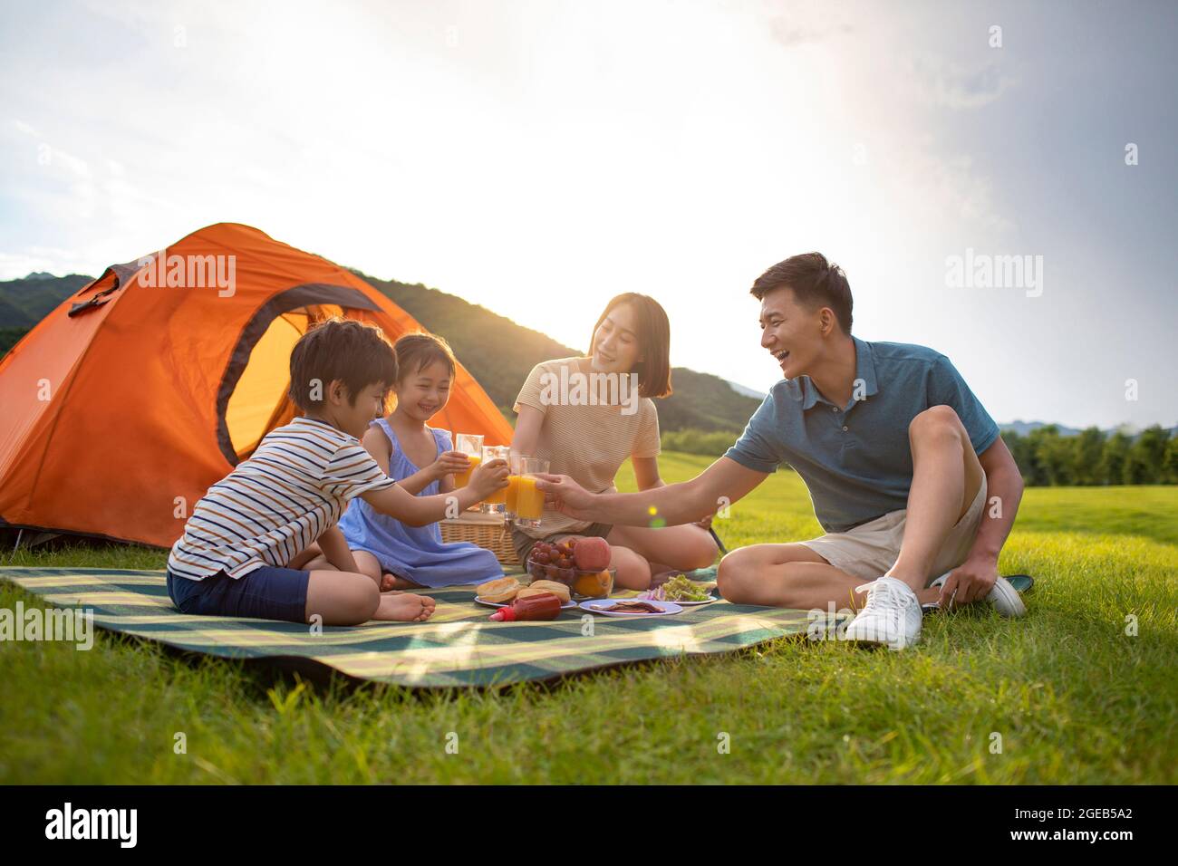 Happy young Chinese family having a picnic outdoors Stock Photo - Alamy