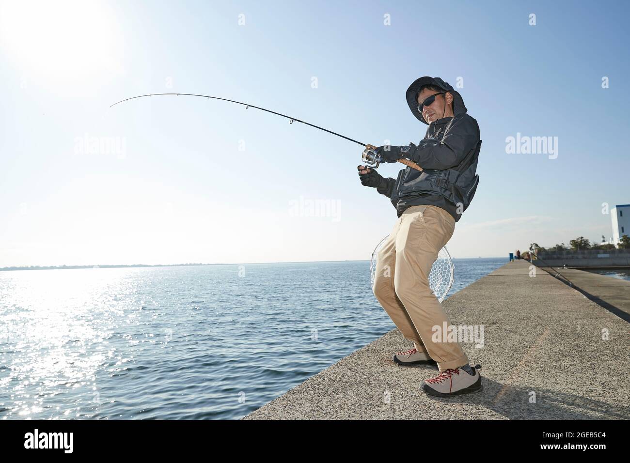 Japanese man fishing Stock Photo - Alamy