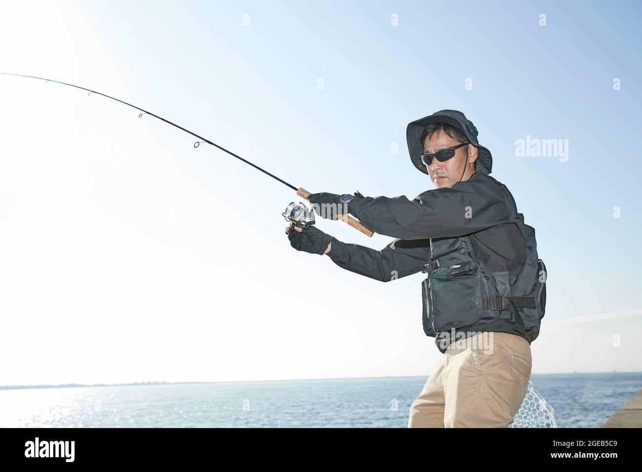 Japanese man fishing Stock Photo - Alamy
