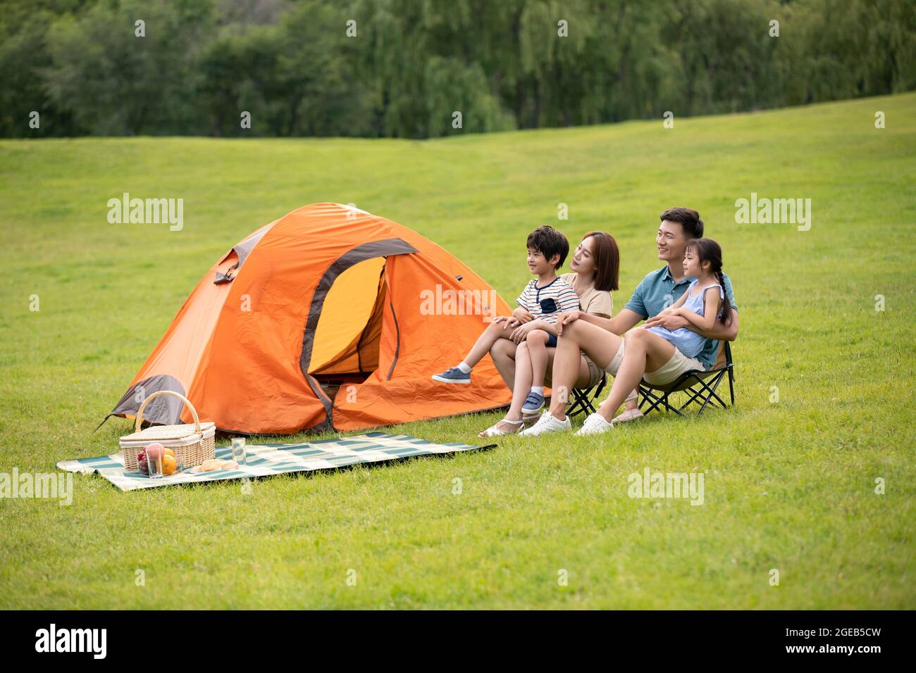 Happy young Chinese family camping outdoors Stock Photo - Alamy