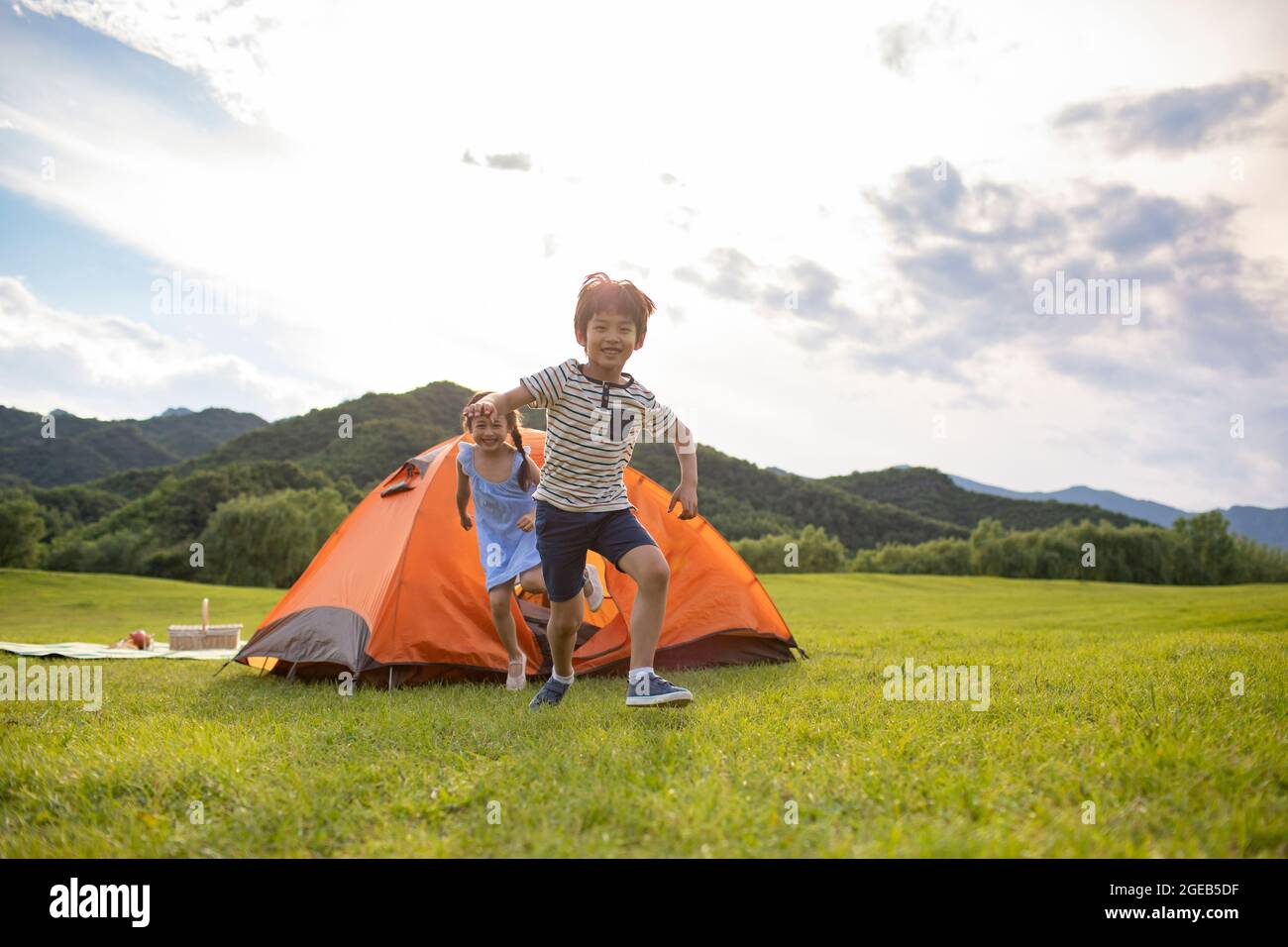 Chinese children camping on meadow Stock Photo - Alamy