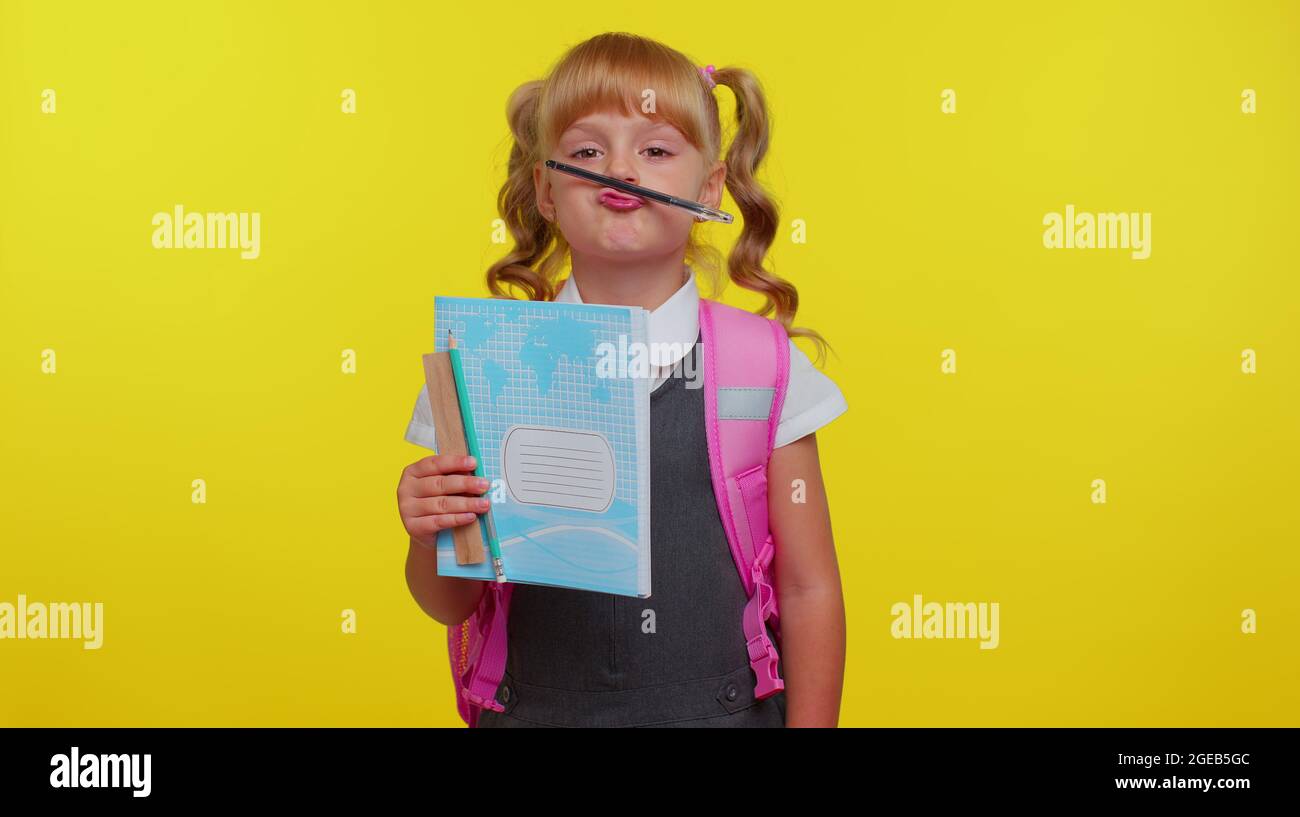 Funny joyful kid primary school girl making playful silly facial ...