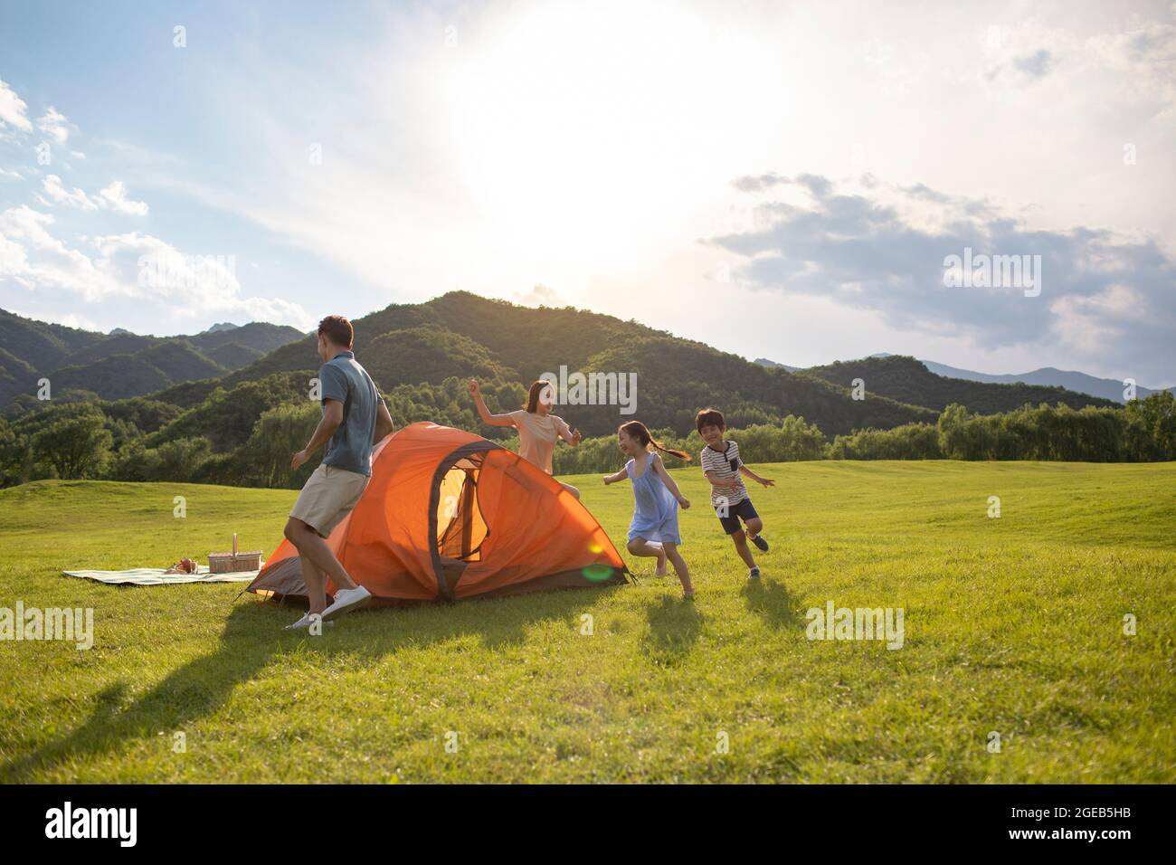 Happy young Chinese family camping outdoors Stock Photo - Alamy