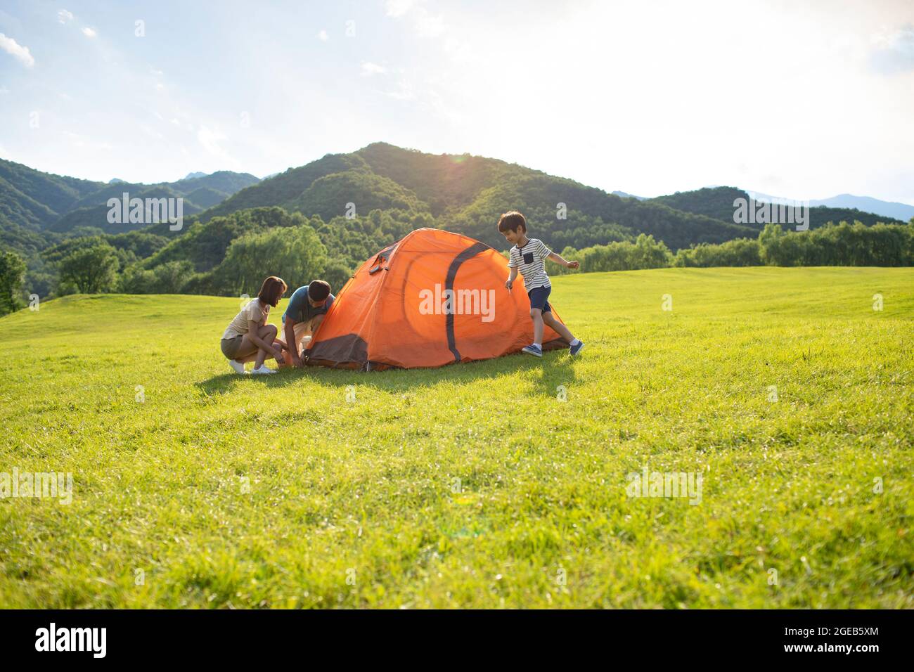 Happy young Chinese family camping outdoors Stock Photo - Alamy