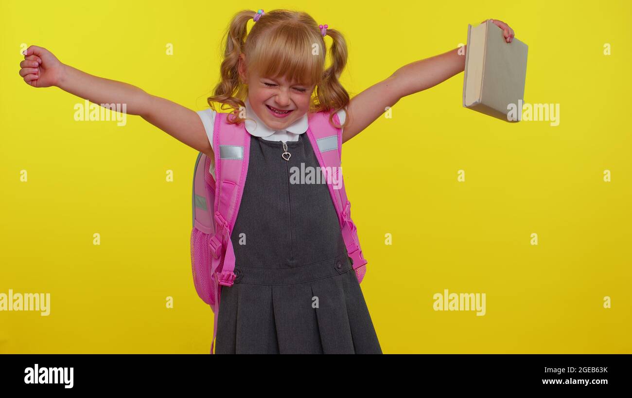Happy cute teen girl kid in school uniform celebrate success win doing ...