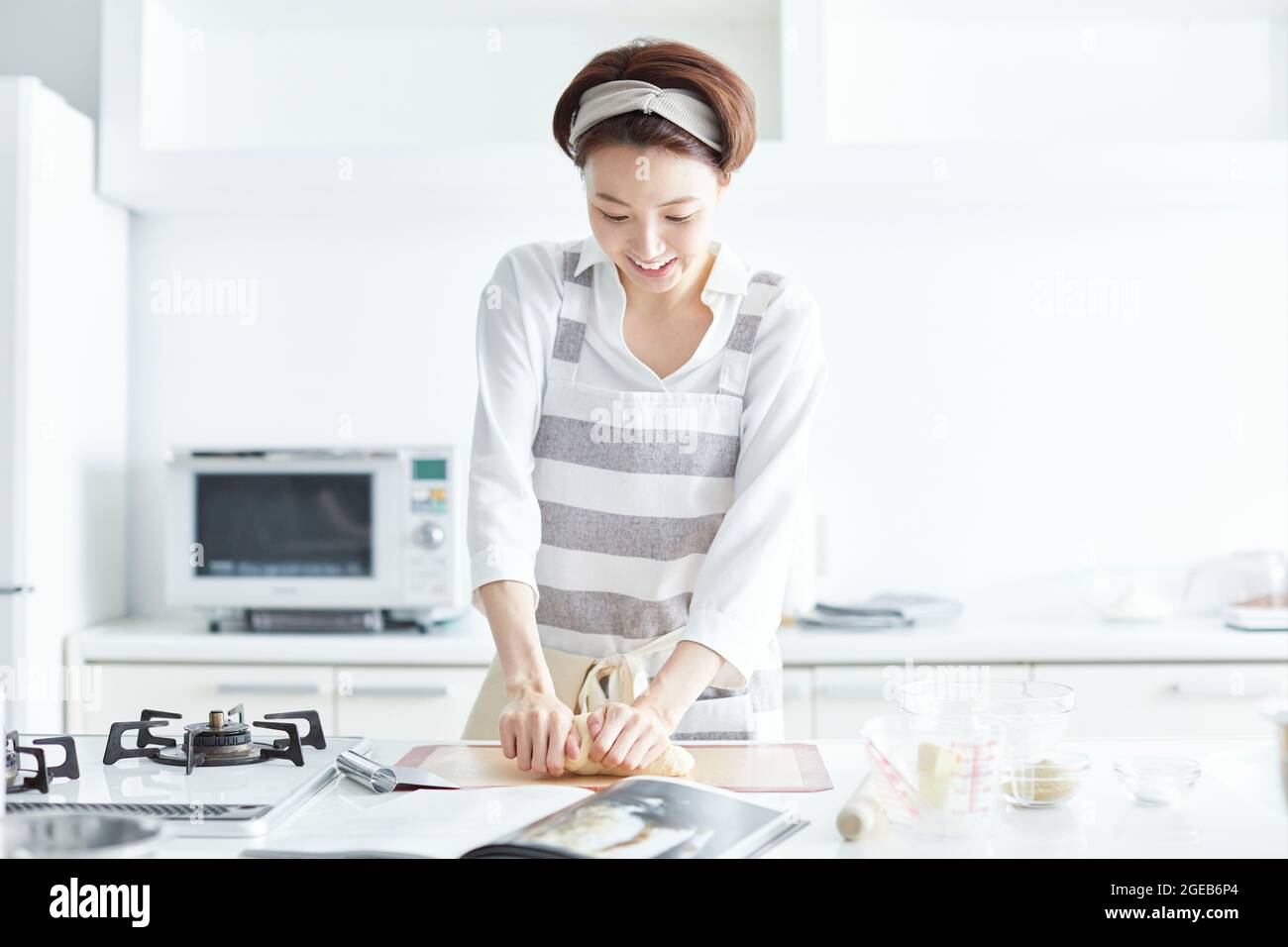 Japanese woman cooking at home Stock Photo - Alamy