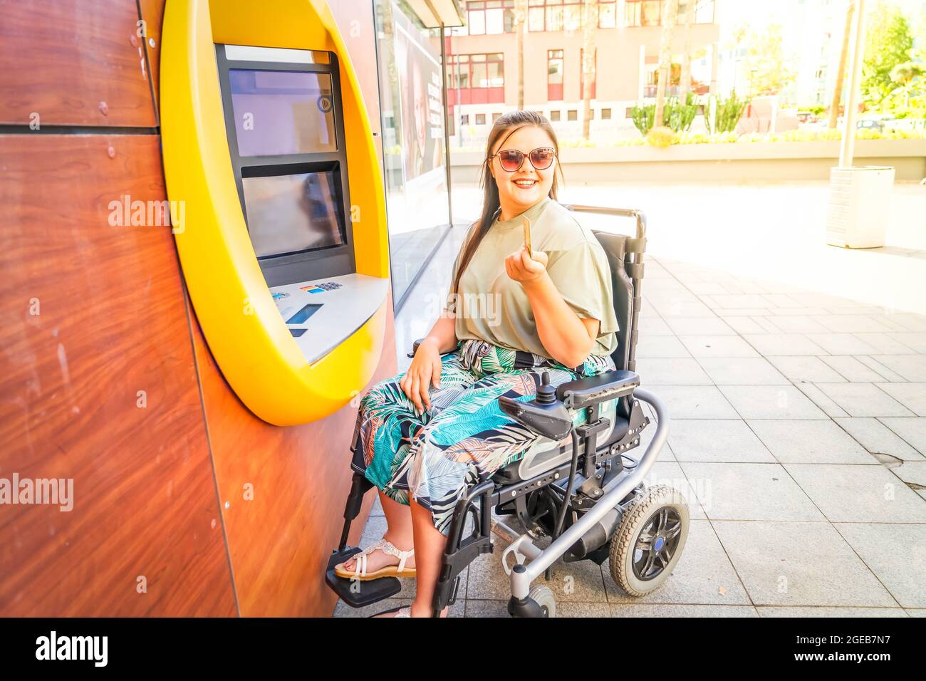 disabled young woman in wheelchair with ATM Stock Photo - Alamy