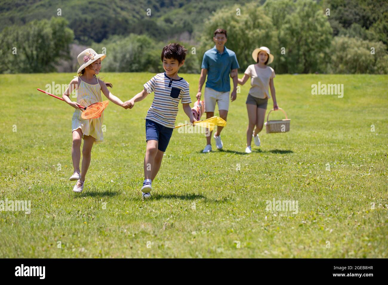 Happy young Chinese family going for picnic Stock Photo - Alamy