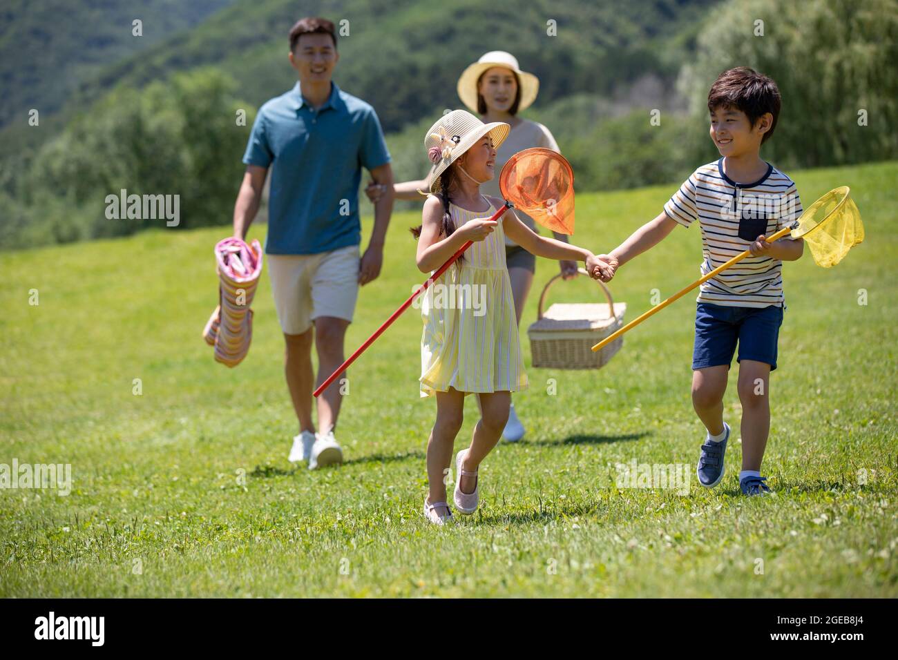 Happy young Chinese family going for picnic Stock Photo - Alamy