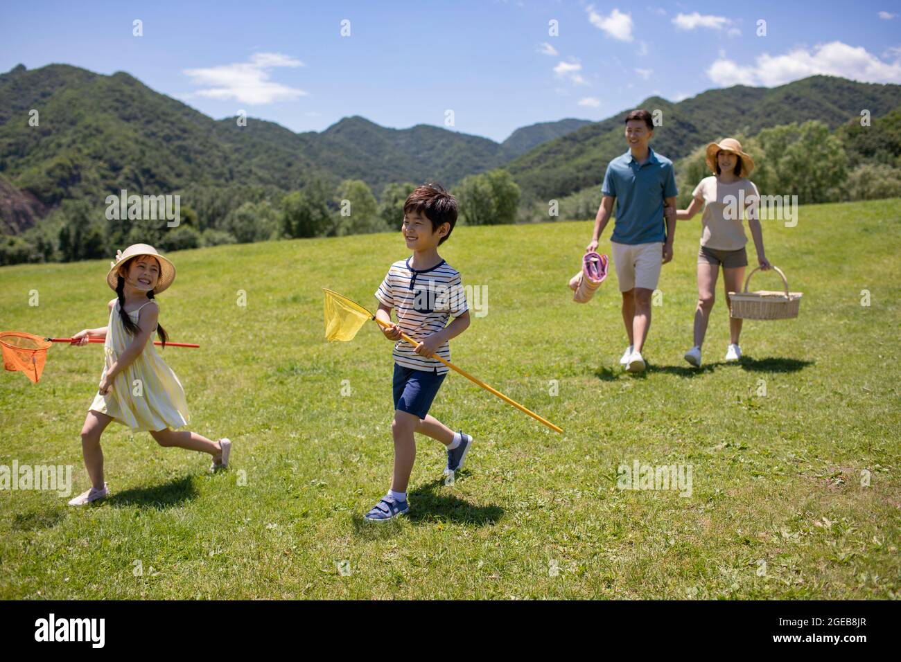 Happy young Chinese family going for picnic Stock Photo - Alamy