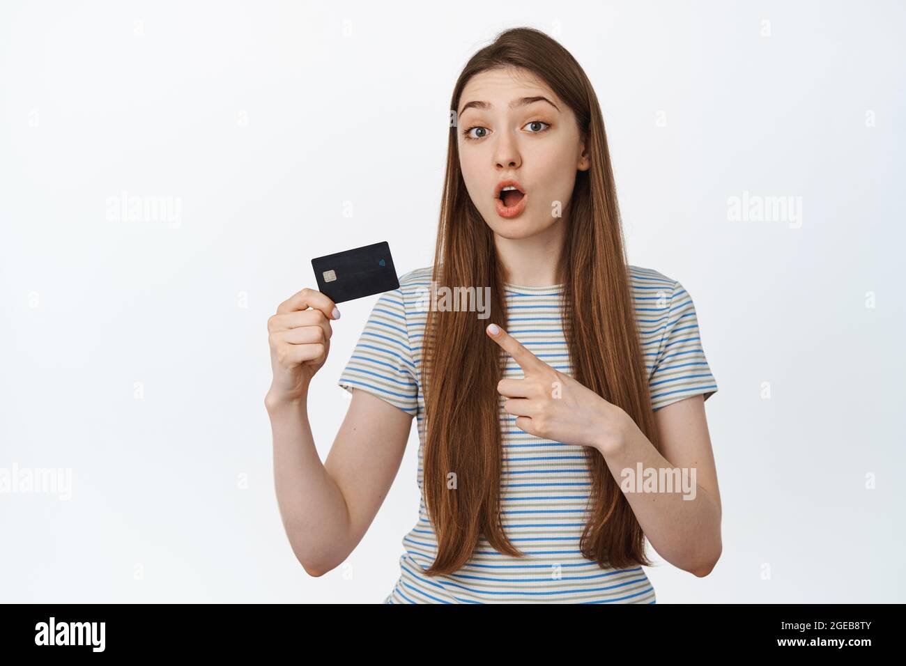 Curious girl points at credit card, asking question about discount or ...