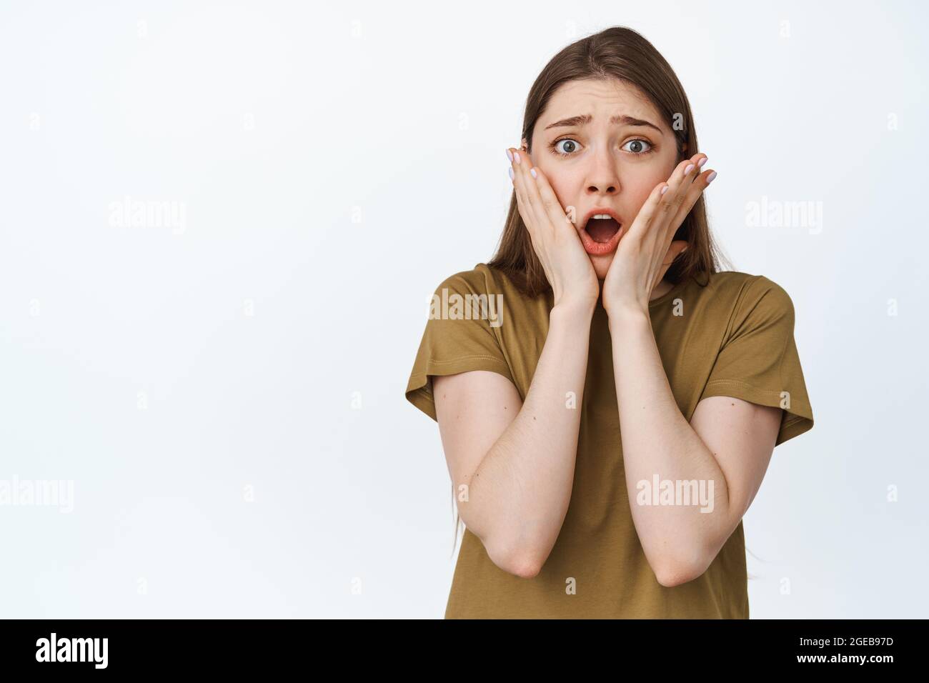 Portrait of concerned and worried woman looking with shock at camera ...