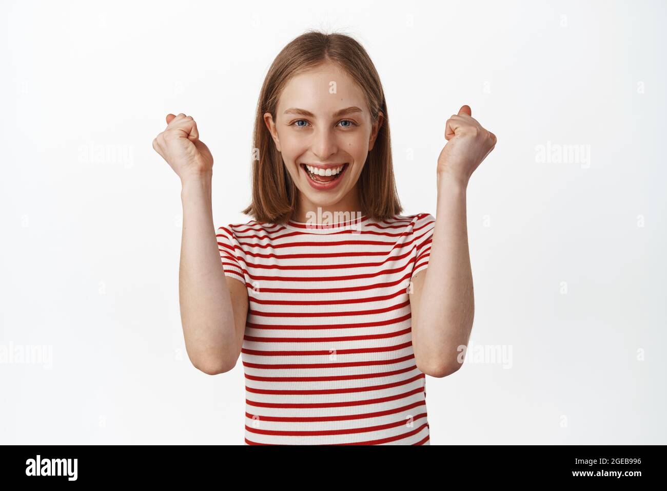 Image of cheerful blond girl winning and celebrating, smiling jumping ...