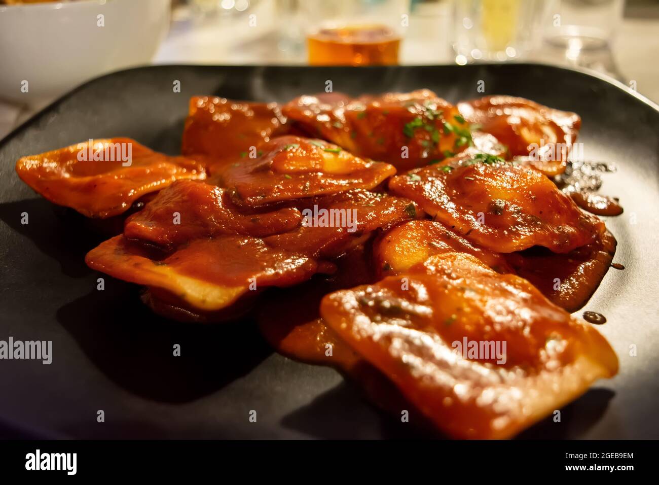 Traditional Italian ravioli filled with ricotta cheese, served with ...