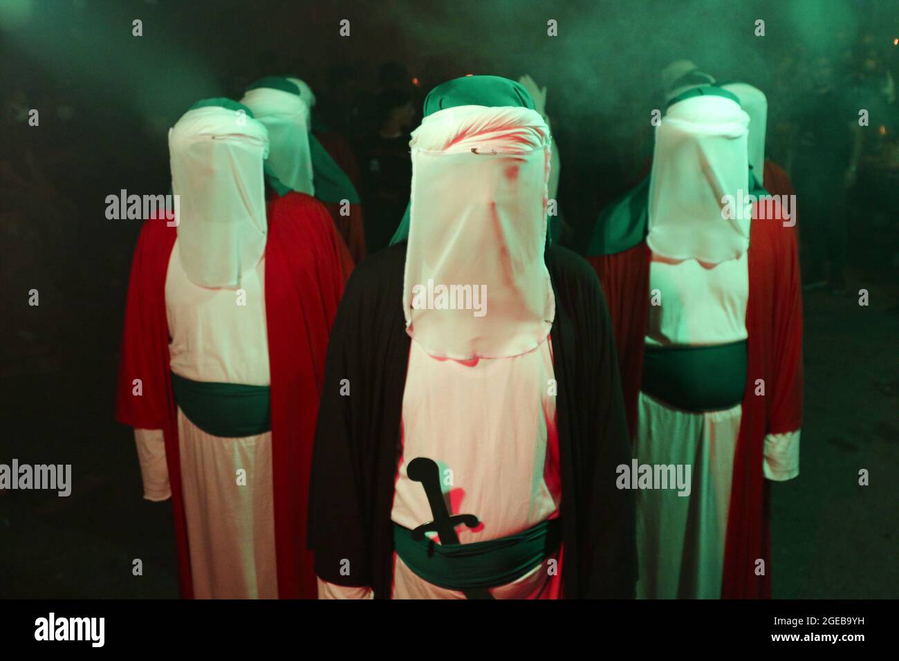 Shiites Muslims attend a mourning ritual on the night of Tasoua, to ...