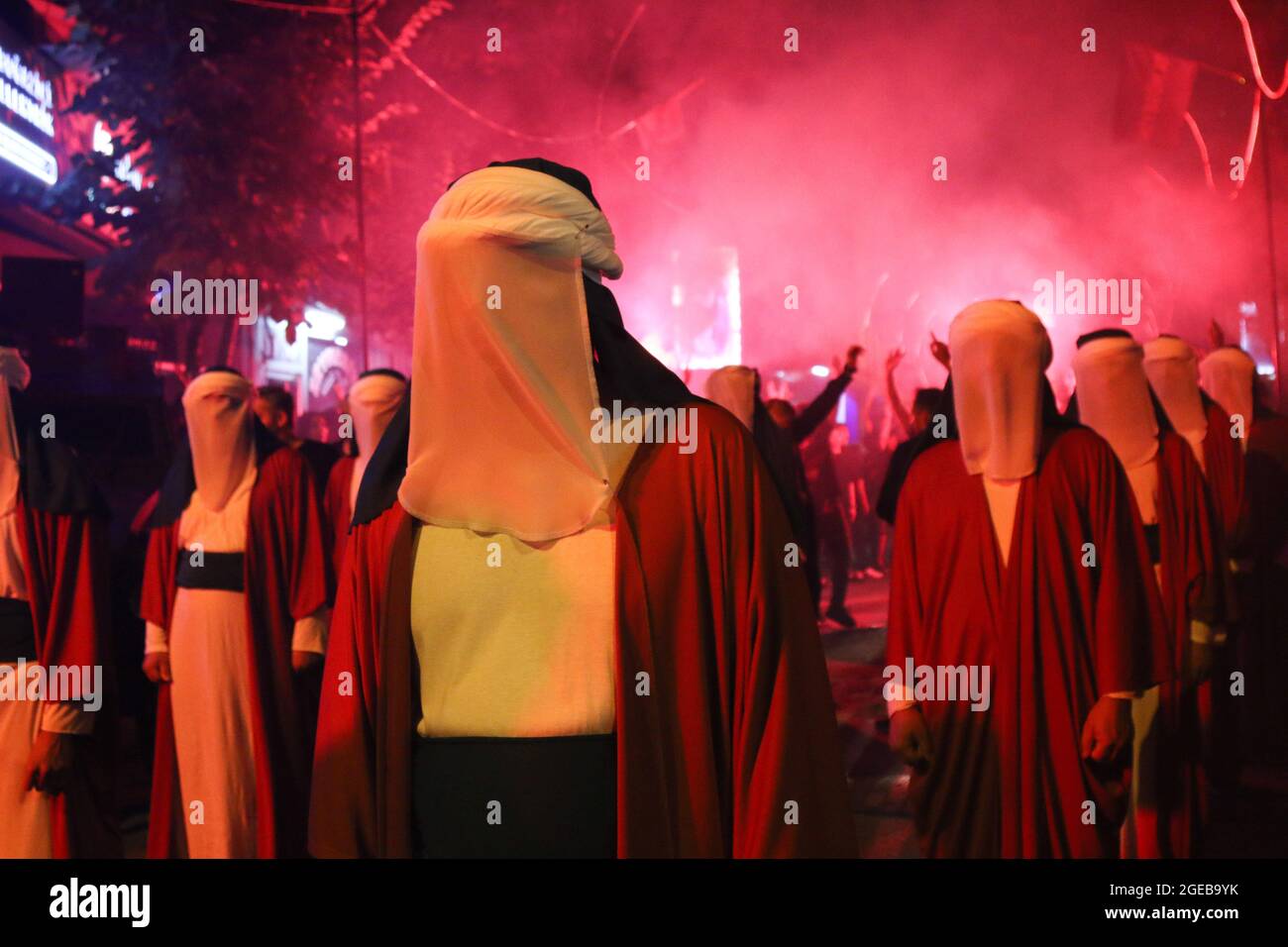 Shiites Muslims attend a mourning ritual on the night of Tasoua, to ...