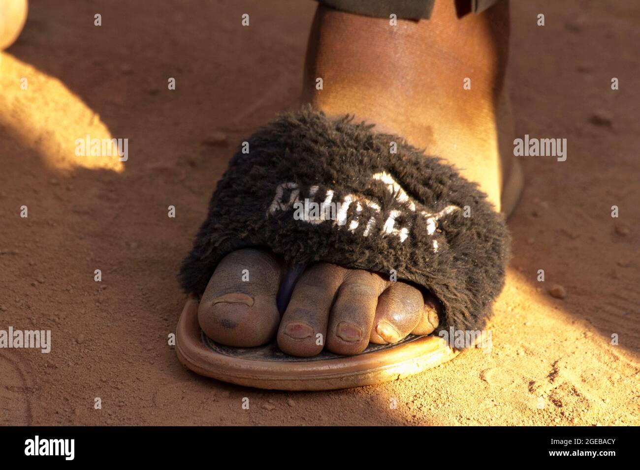 A man with dusty feet seen at a music festival at Dzaleka Refugee Camp ...