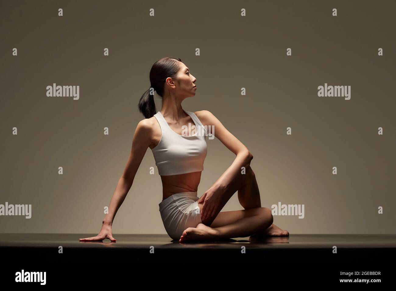 Japanese woman practicing yoga Stock Photo - Alamy
