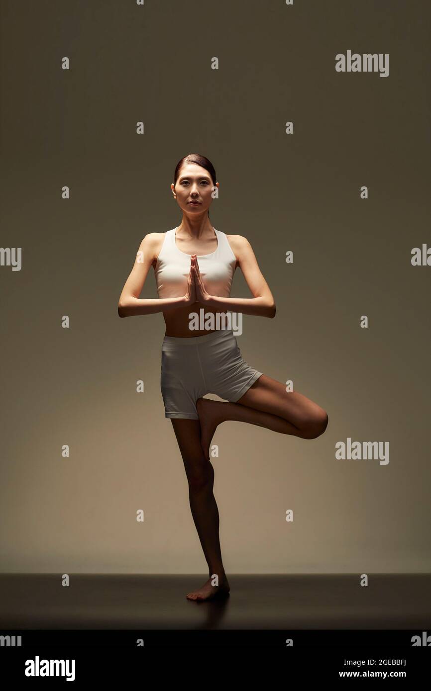 Japanese woman practicing yoga Stock Photo - Alamy